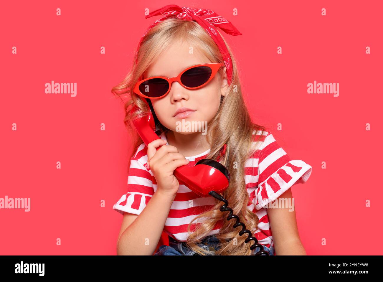 Cute little girl with handset of telephone on red background Stock ...