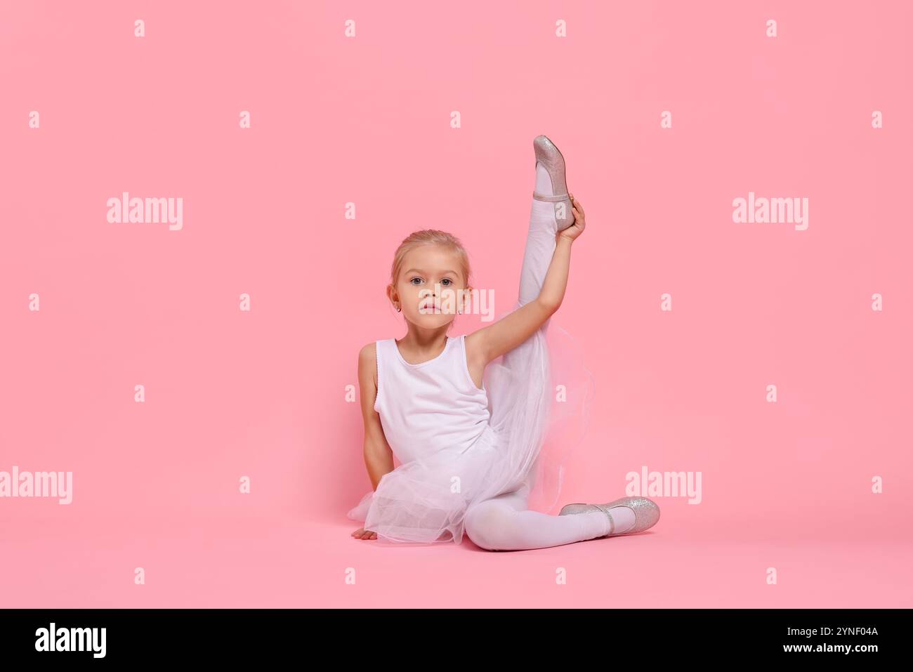 Little girl pretending to be ballerina on pink background. Dreaming of future profession Stock ...