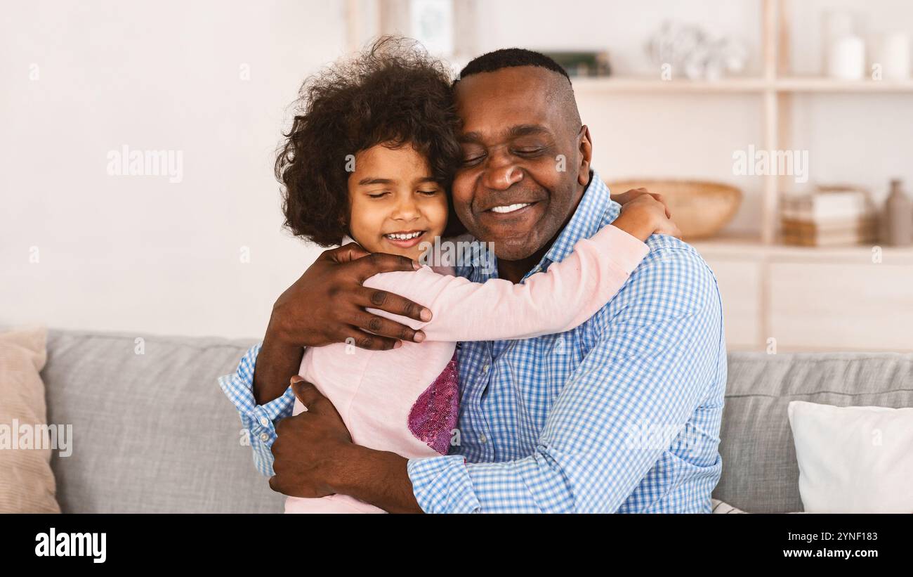 Stay at home, be happy. African American grandpa hugging his lovely ...
