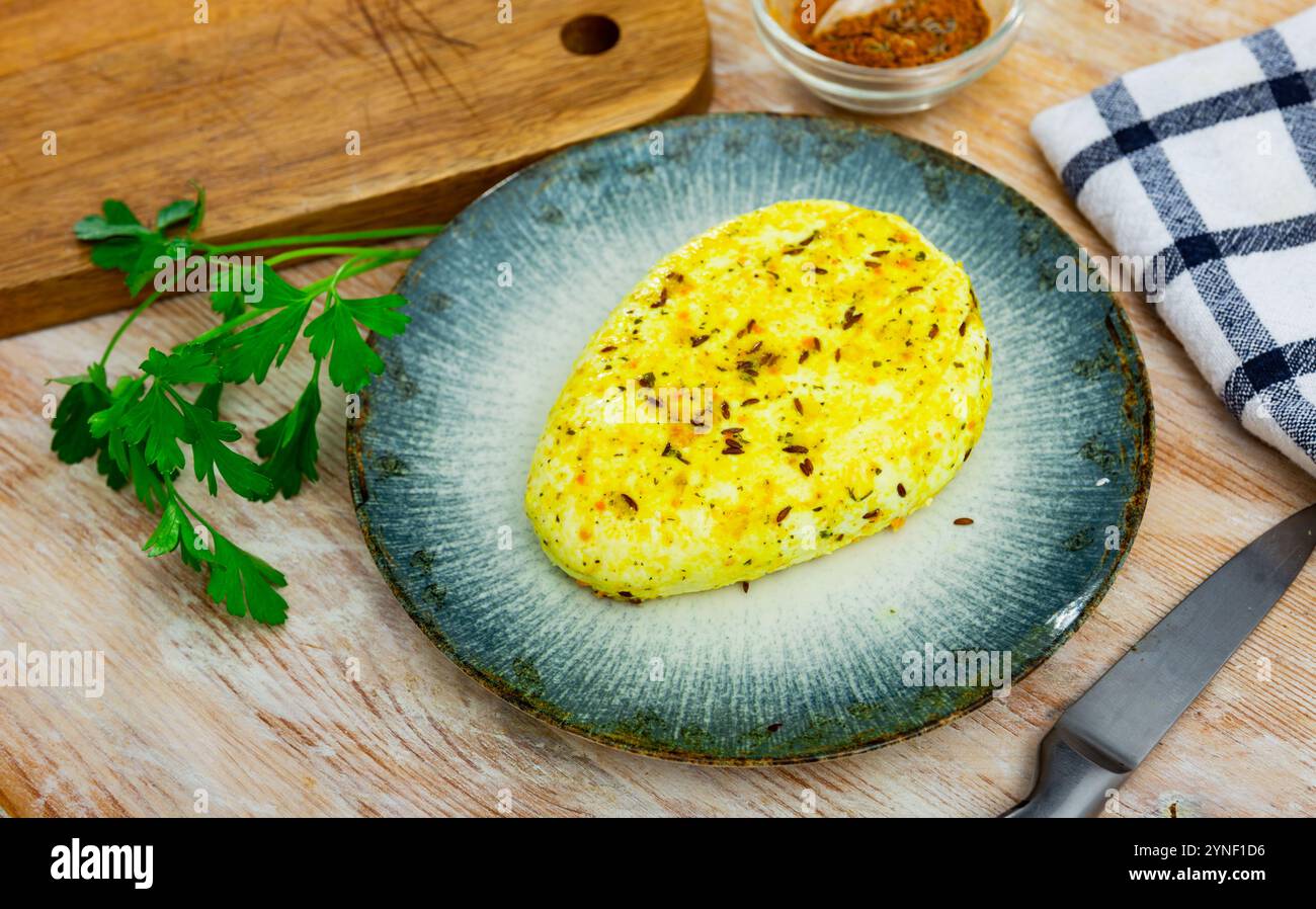 Traditional lithuanian farm cheese on plate with herbs and spices ...