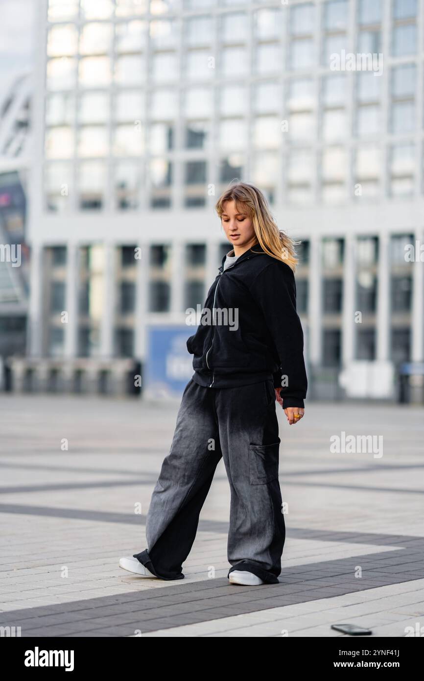 Women dance in the sunlight among modern urban architecture Stock Photo ...