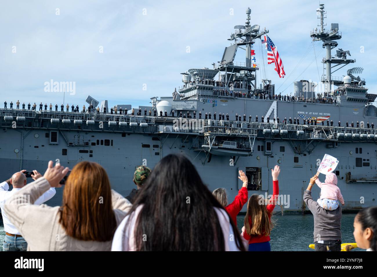 Family and friends watch Sailors and Marines man the rails as the Wasp ...
