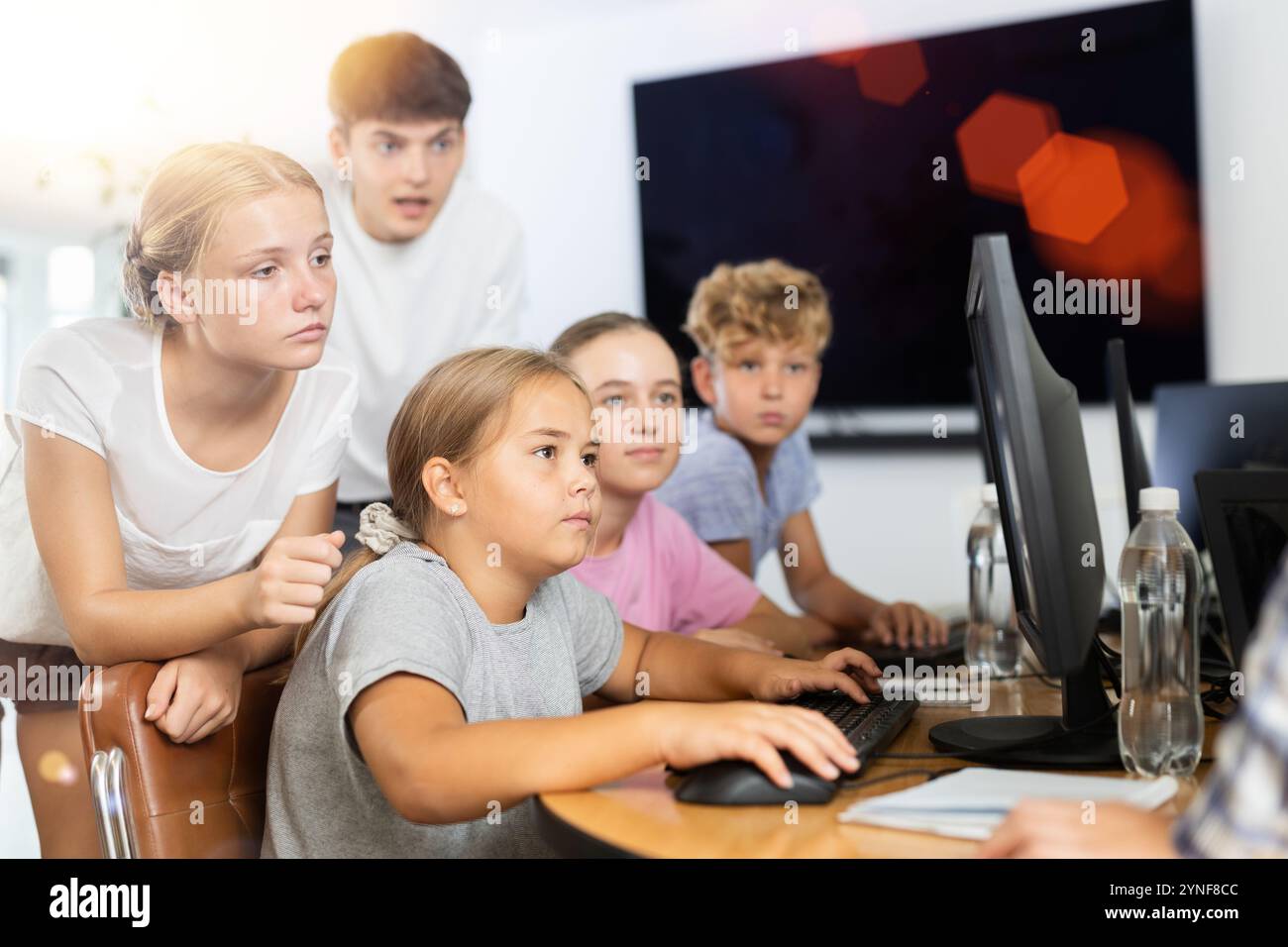 Computer lesson in classroom - classmates solve problems on computer ...