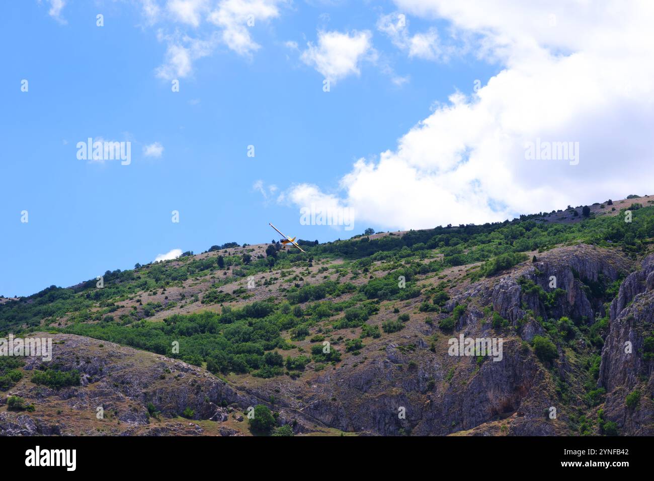 Single engine propeller plane maneuvering at low altitude close to the ...