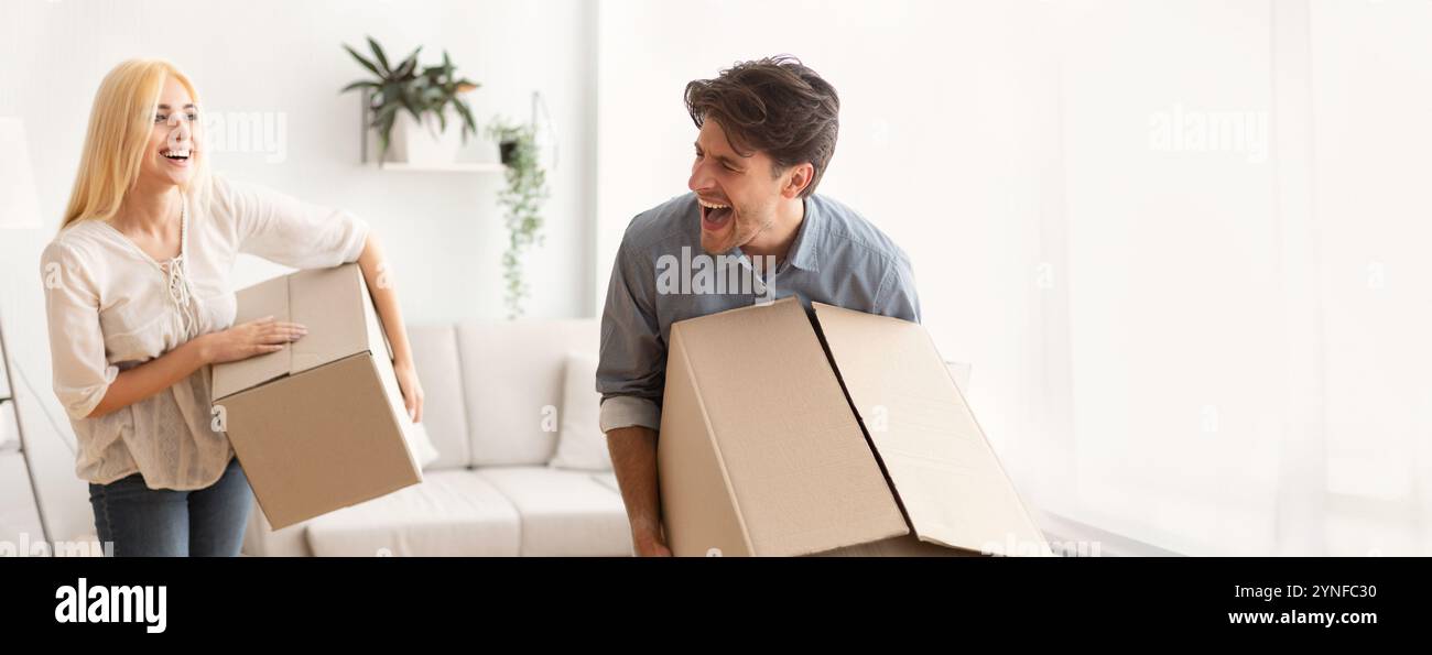 Happy couple moving boxes into their new apartment during daytime Stock ...