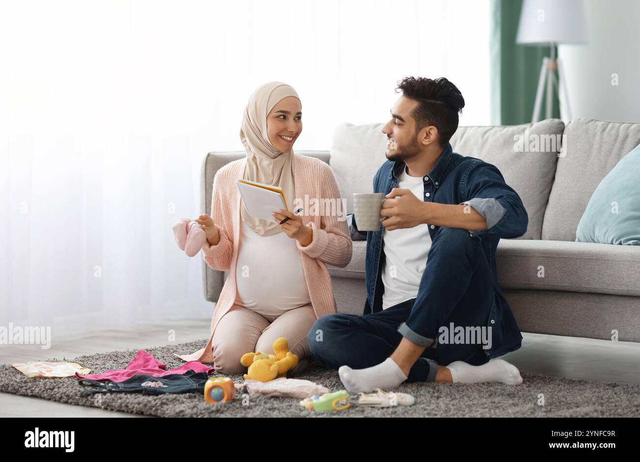 Happy pregnant muslim couple getting geady for childbirth, making ...