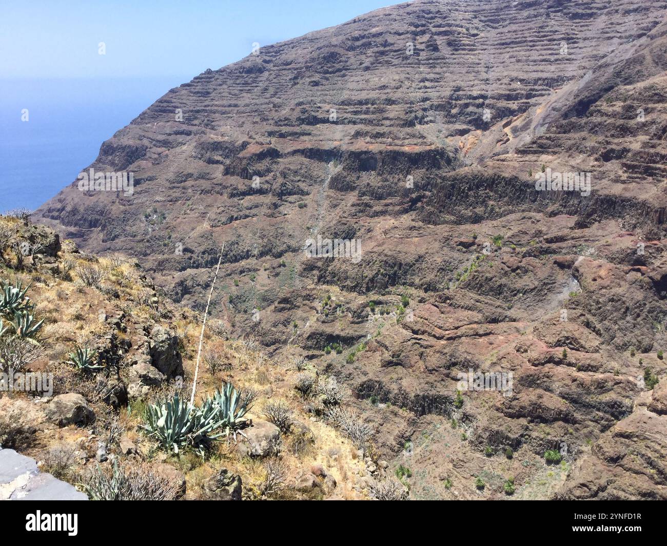 The rugged cliffs reveal a stunning coastline with deep blue waters ...