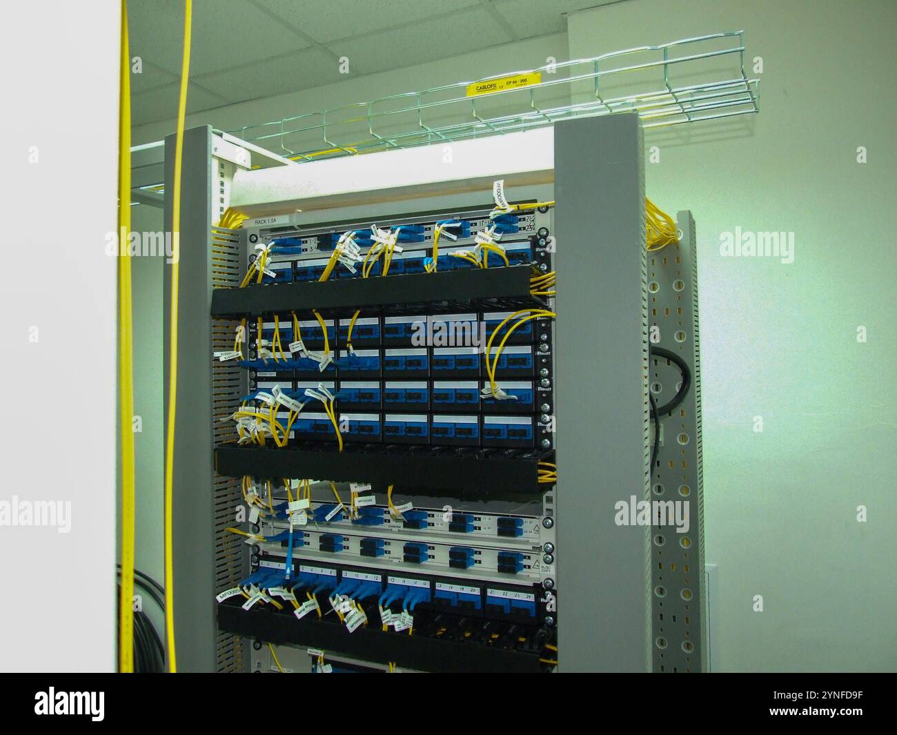 A data center rack filled with organized network equipment and cables ...