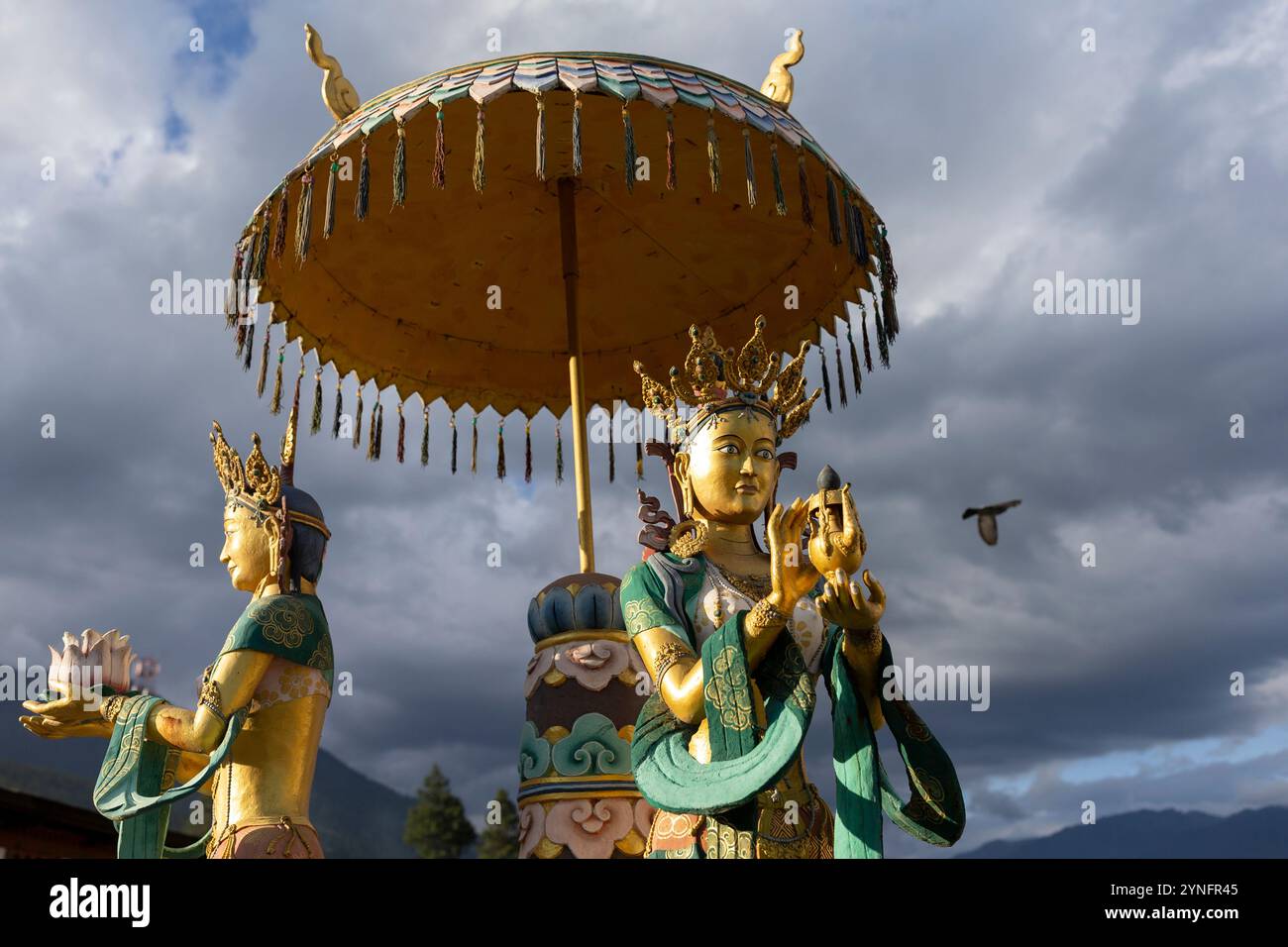 Golden female god statues at the roundabout in Thimphu, Bhutan Stock ...