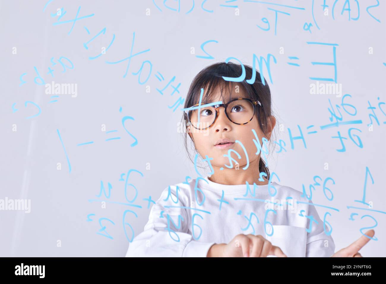 Japanese girl in glasses pointing at a whiteboard with math formulas ...