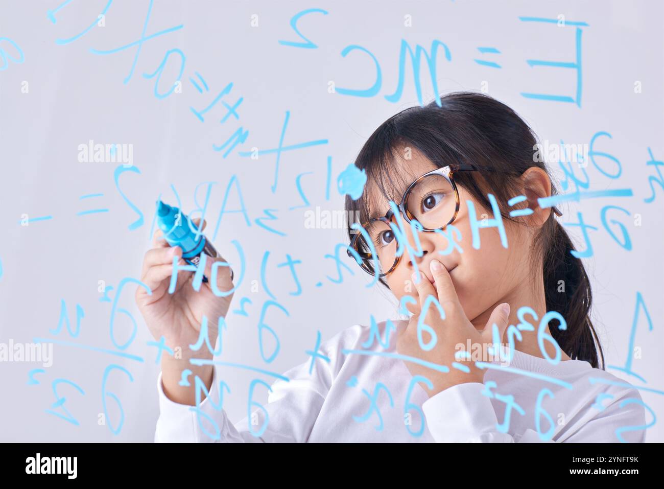 Japanese girl writing on a whiteboard with math formulas Stock Photo ...