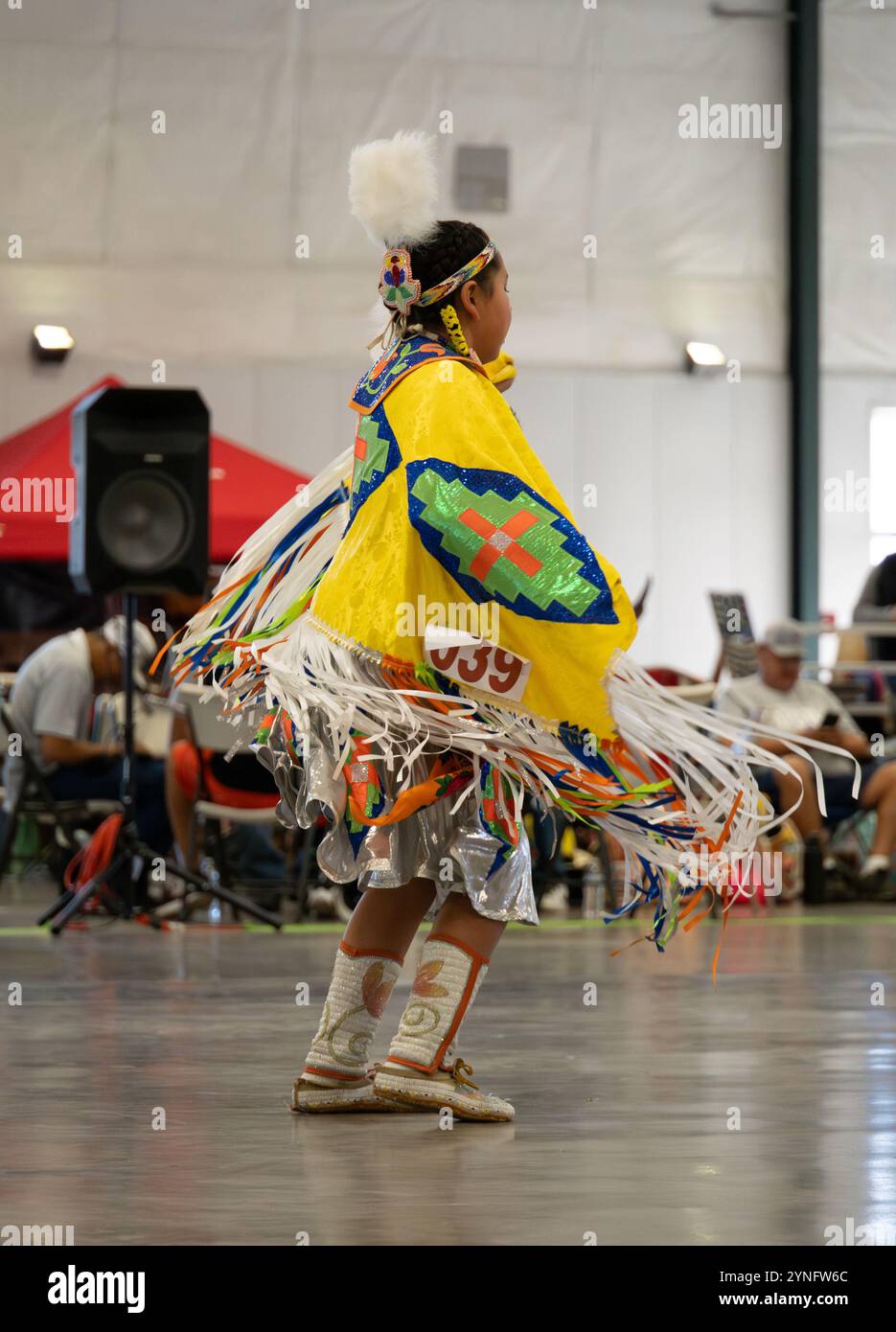 Pre teen girl fancy shawl dancer with a bright yellow ribbon shawl dancing at the Last Chance ...