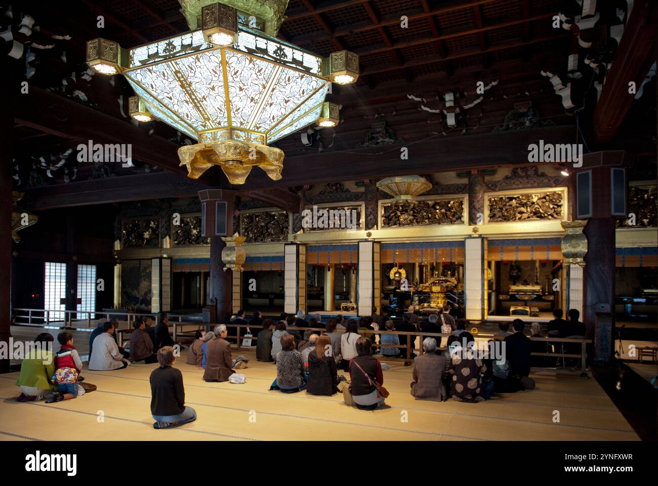 Worshipers sitting on the tatami mat floor inside the Goeido (Founders ...