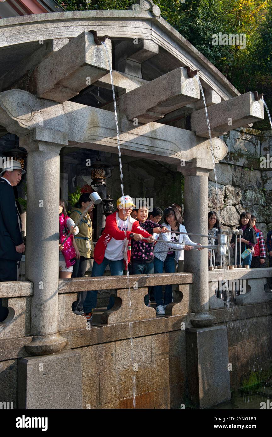Visitors at Kiyomizu-dera Temple drink from the Otowanotaki (Sacred ...