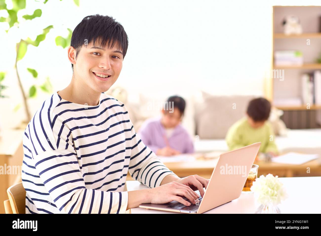 Japanese man sitting at home with his laptop Stock Photo - Alamy