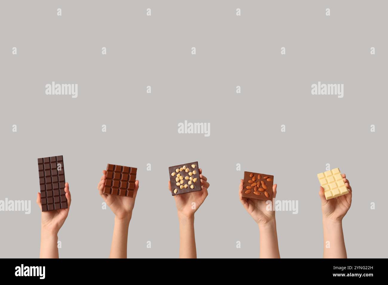 Female hands with different sweet chocolate bars on grey background ...