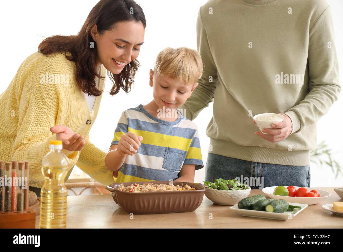 Little boy with his parents cooking Fajita at table in kitchen Stock ...