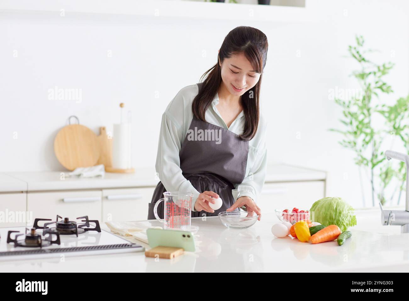 Japanese woman cooking in the kitchen Stock Photo - Alamy