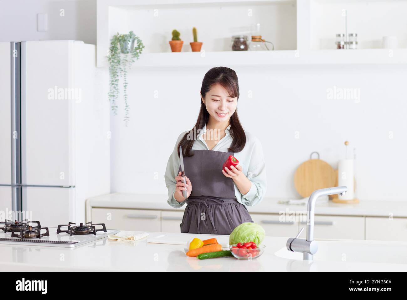 Japanese woman cooking in the kitchen Stock Photo - Alamy