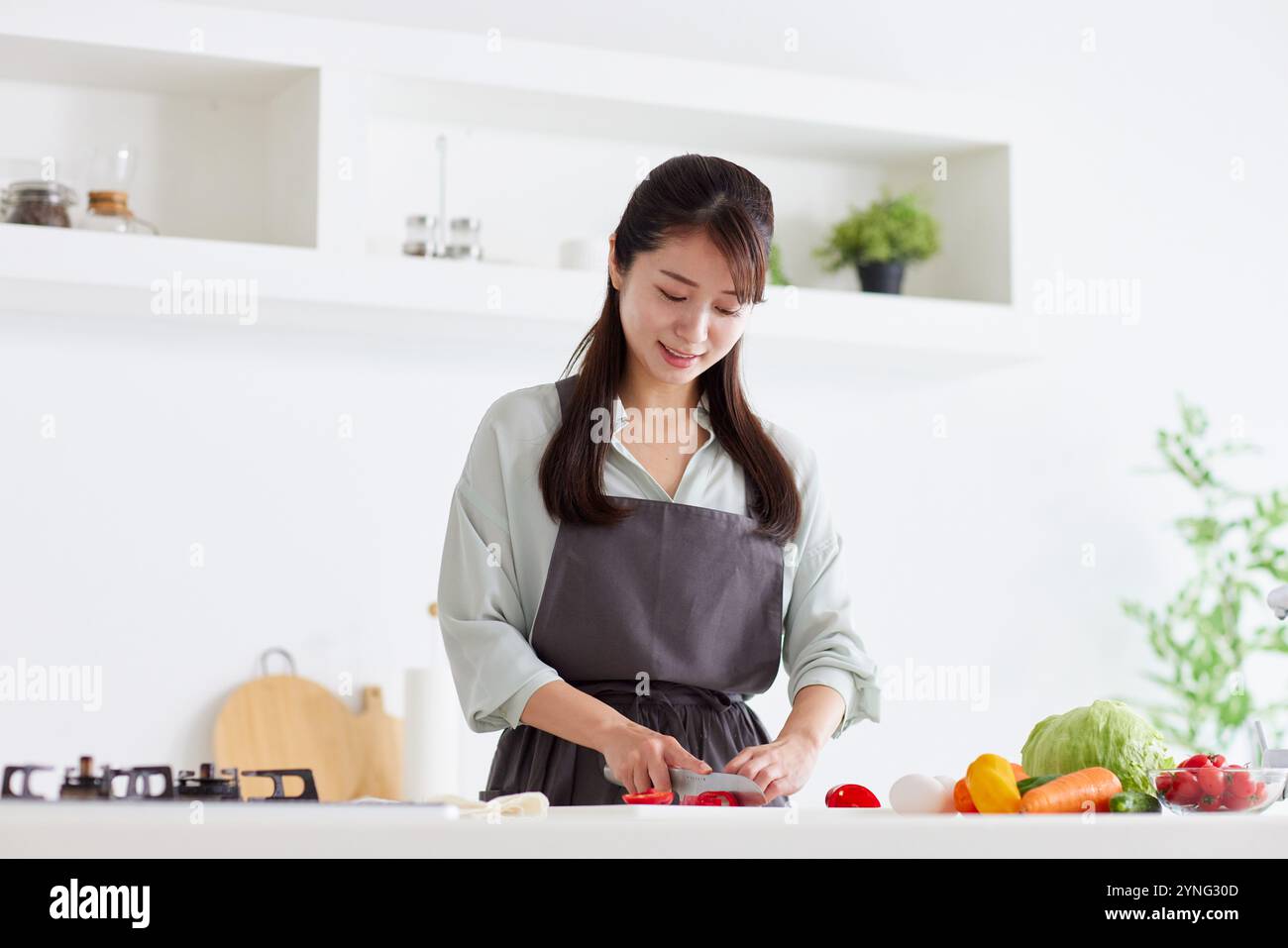 Japanese woman cooking in the kitchen Stock Photo - Alamy