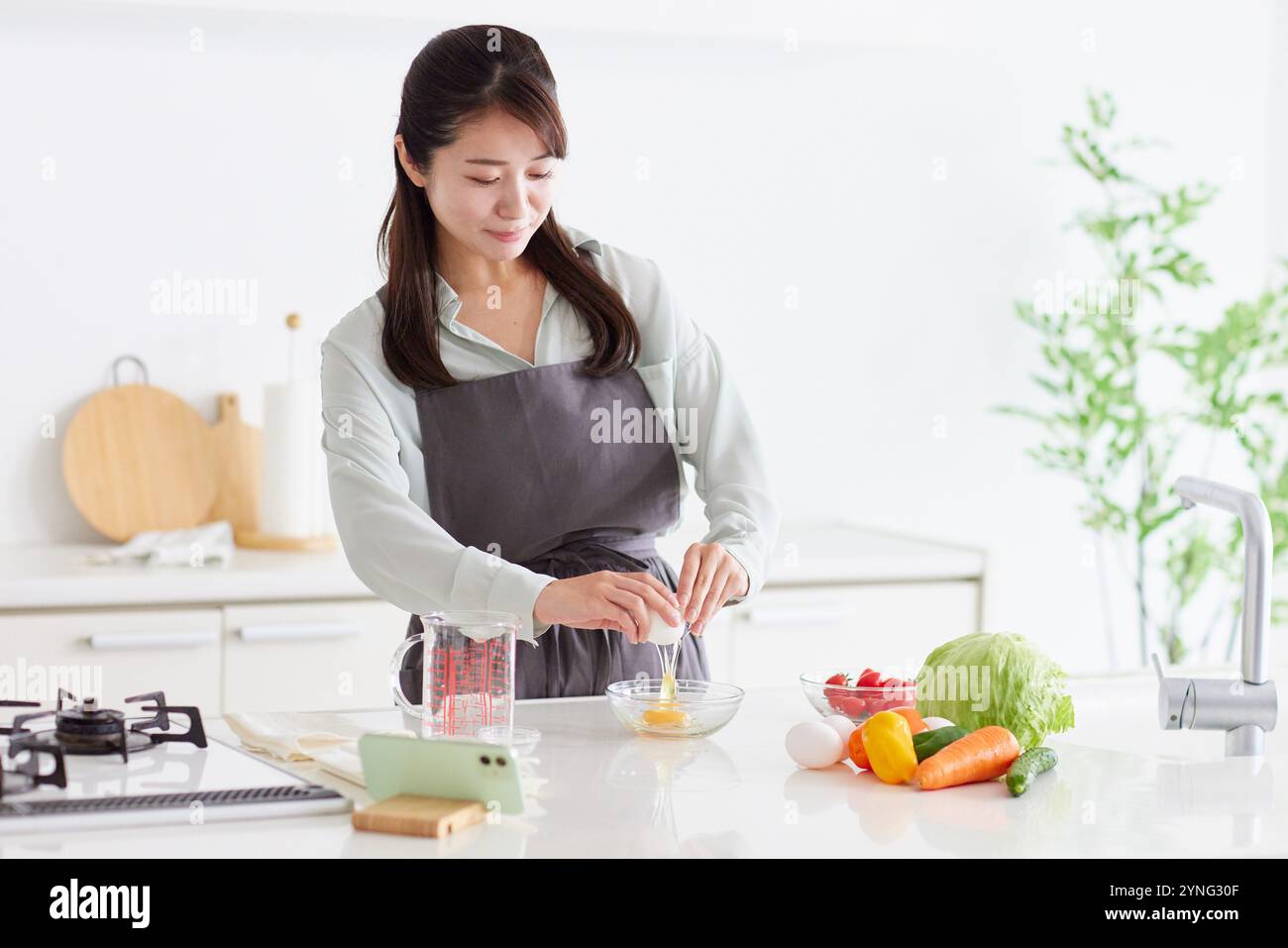 Japanese woman cooking in the kitchen Stock Photo - Alamy