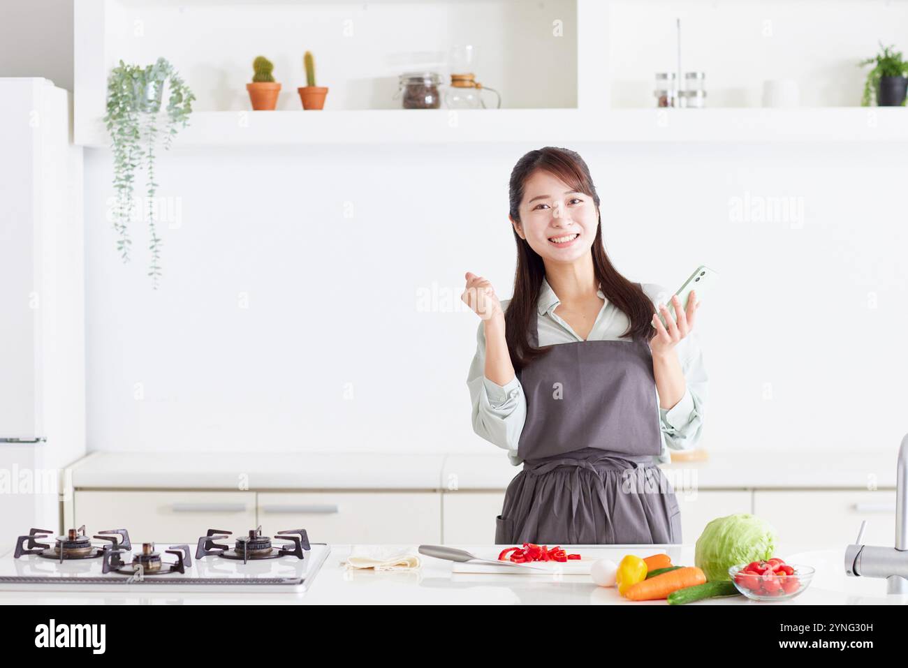Japanese woman cooking in the kitchen Stock Photo - Alamy