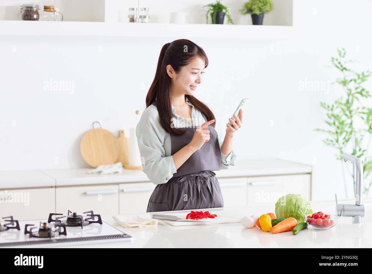 Japanese woman cooking in the kitchen Stock Photo - Alamy