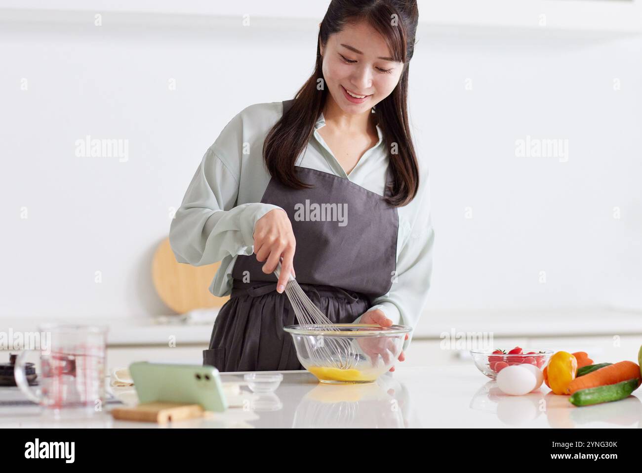 Japanese woman cooking in the kitchen Stock Photo - Alamy