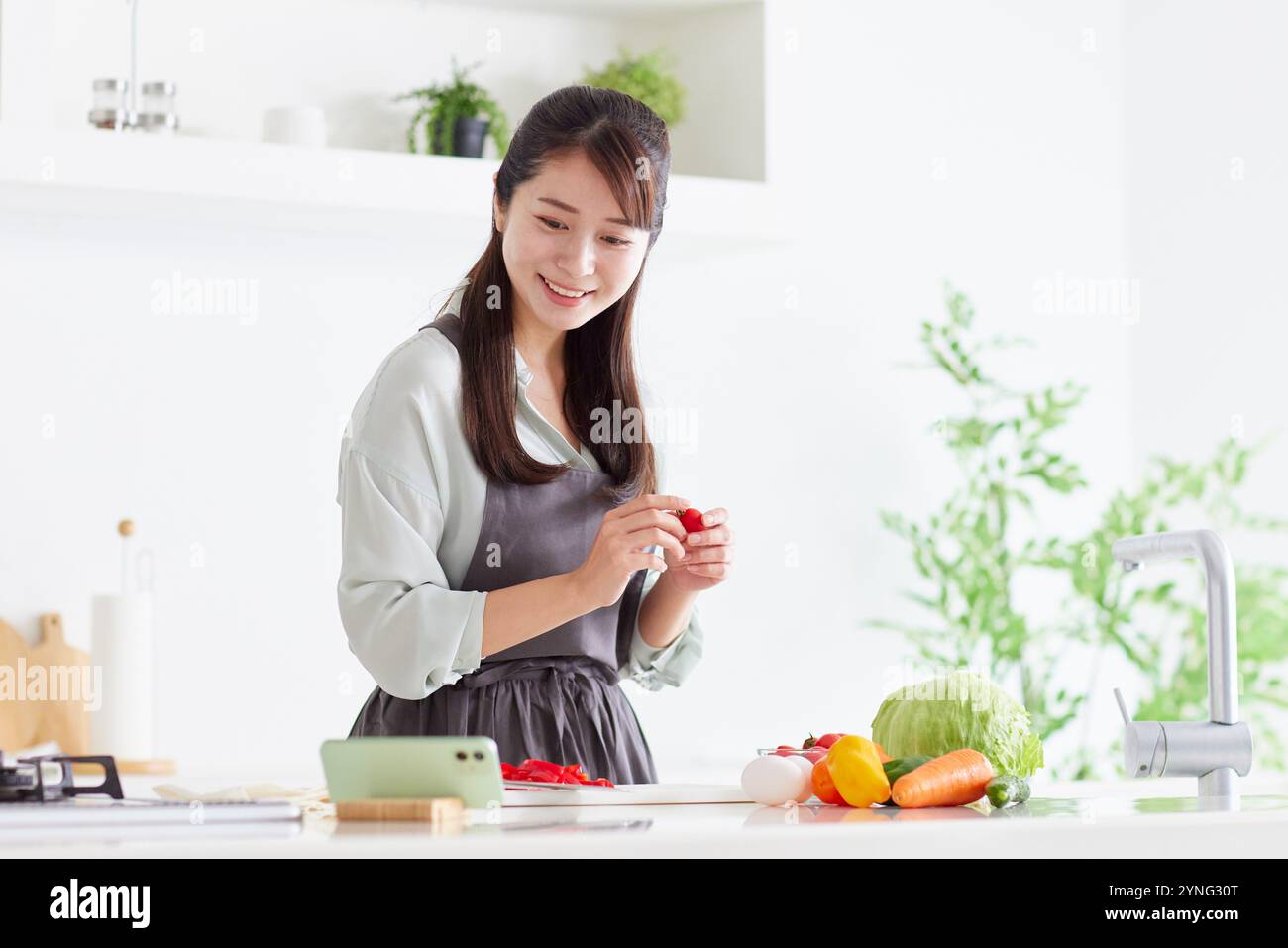 Japanese woman cooking in the kitchen Stock Photo - Alamy