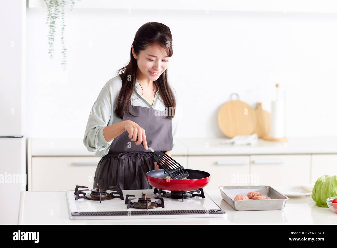 Japanese woman cooking in the kitchen Stock Photo - Alamy