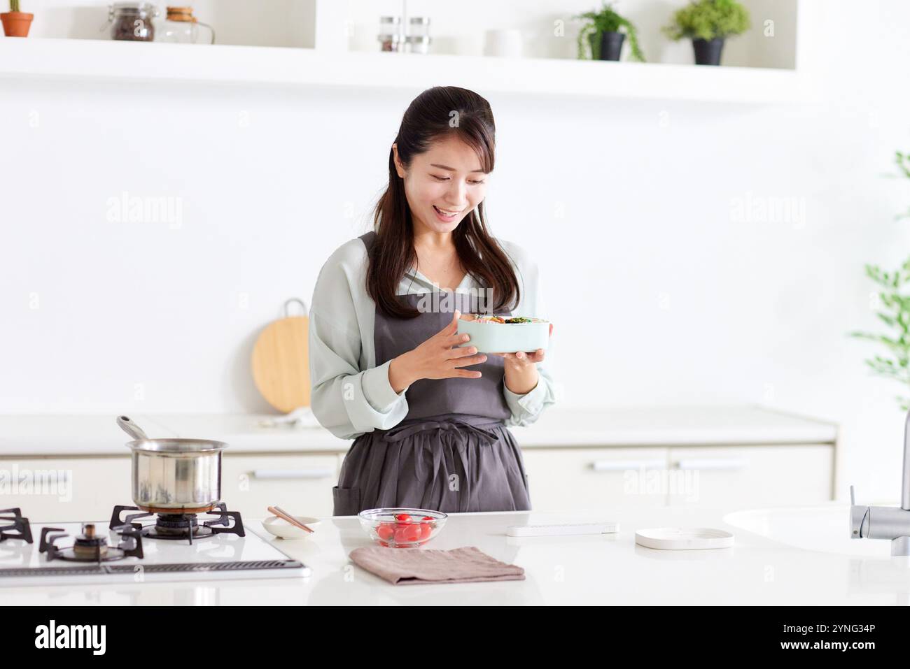 Japanese woman cooking in the kitchen Stock Photo - Alamy