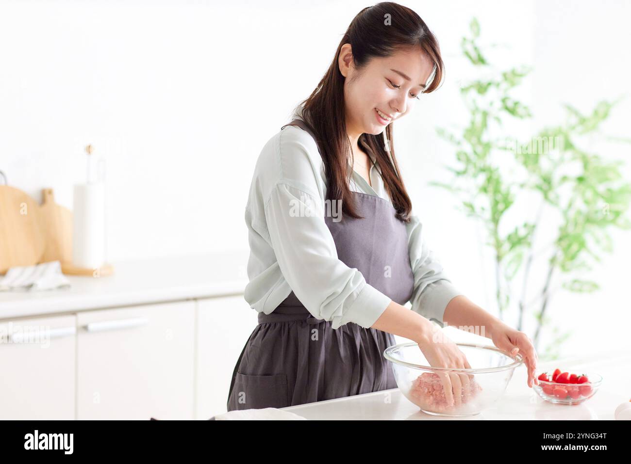 Japanese woman cooking in the kitchen Stock Photo - Alamy