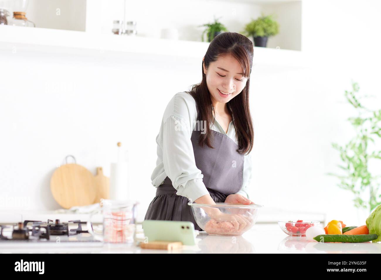 Japanese woman cooking in the kitchen Stock Photo - Alamy