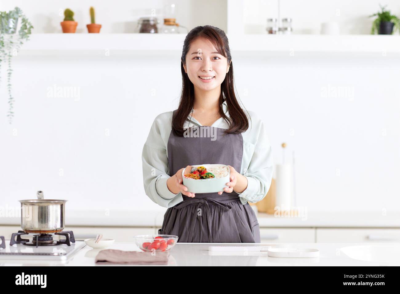 Japanese woman cooking in the kitchen Stock Photo - Alamy