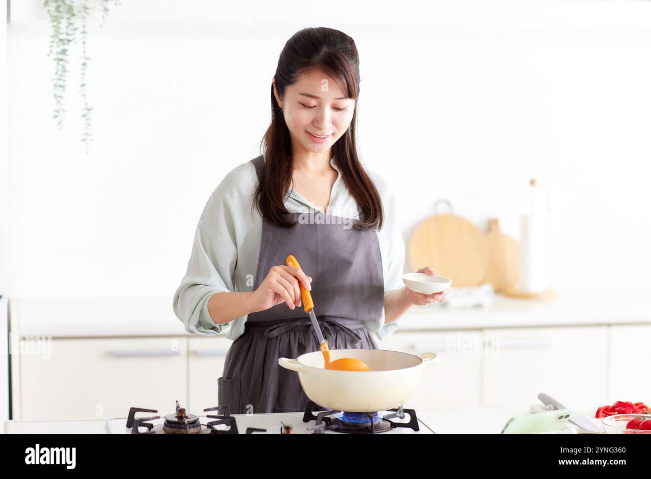 Japanese woman cooking in the kitchen Stock Photo - Alamy