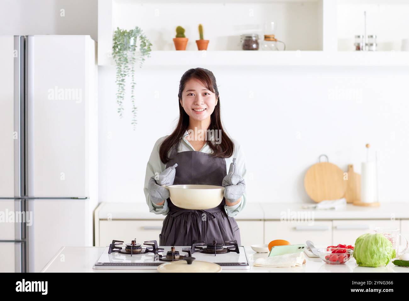 Japanese woman cooking in the kitchen Stock Photo - Alamy