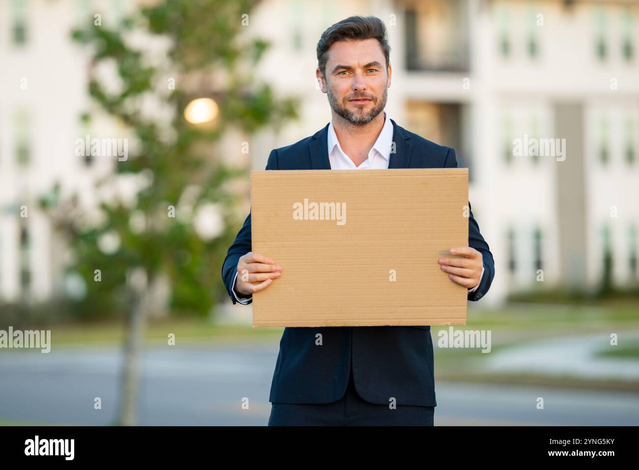 Man in business suit holds the sign, blank card. Placard ready for your ...