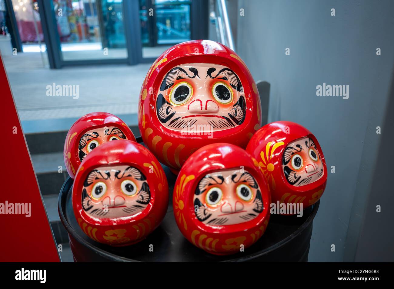 This vibrant image showcases a collection of traditional Japanese Daruma dolls, with their ...