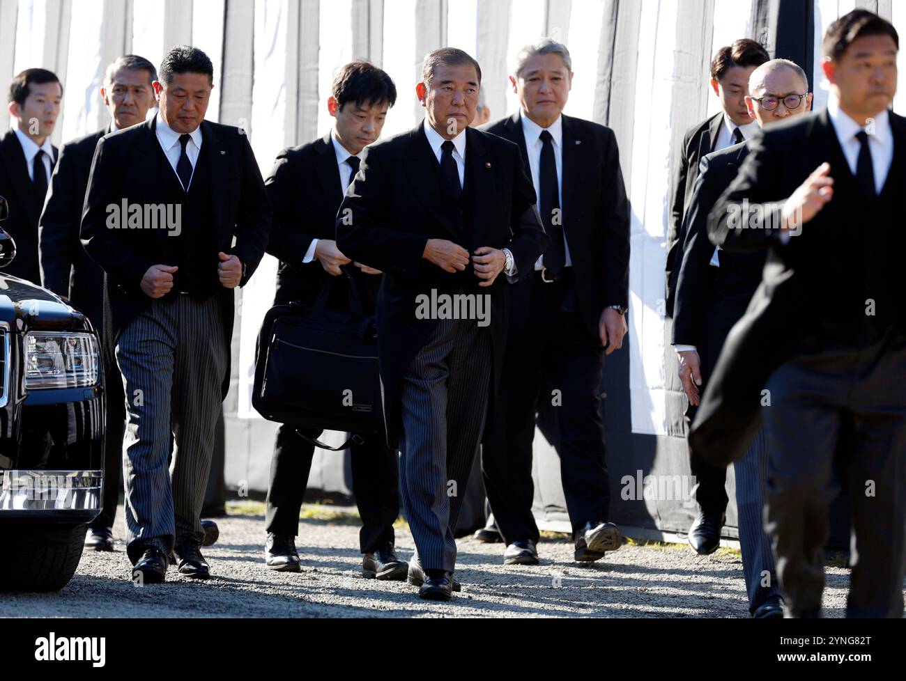 Japan's Prime Minister Shigeru Ishiba, center, arrives at a funeral ...