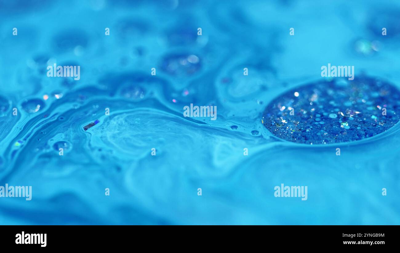 Acrylic paint flow. Shiny fluid drop. Defocused blue color sparkling ...
