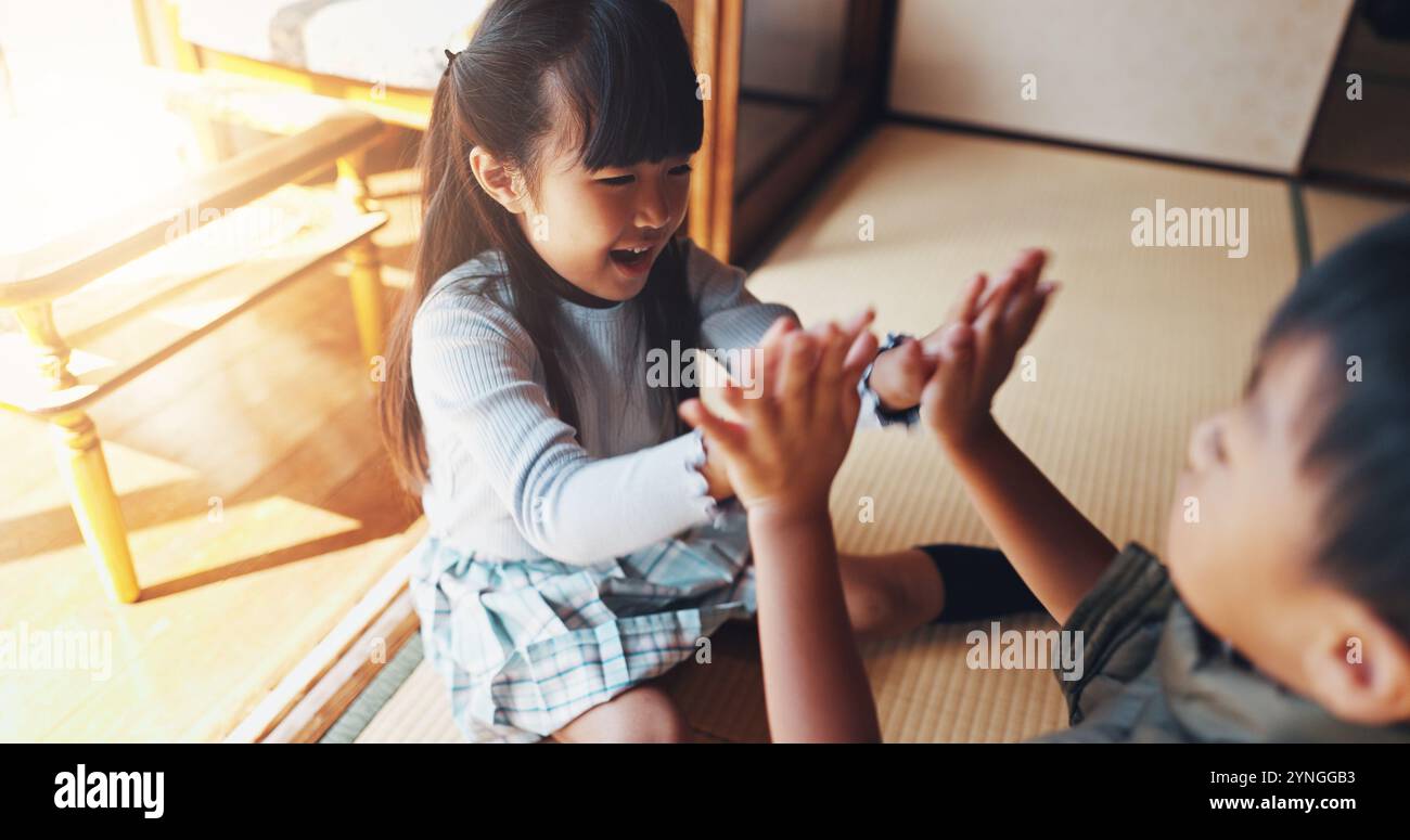 Home, kids and playing clapping game for bonding, cognitive development ...