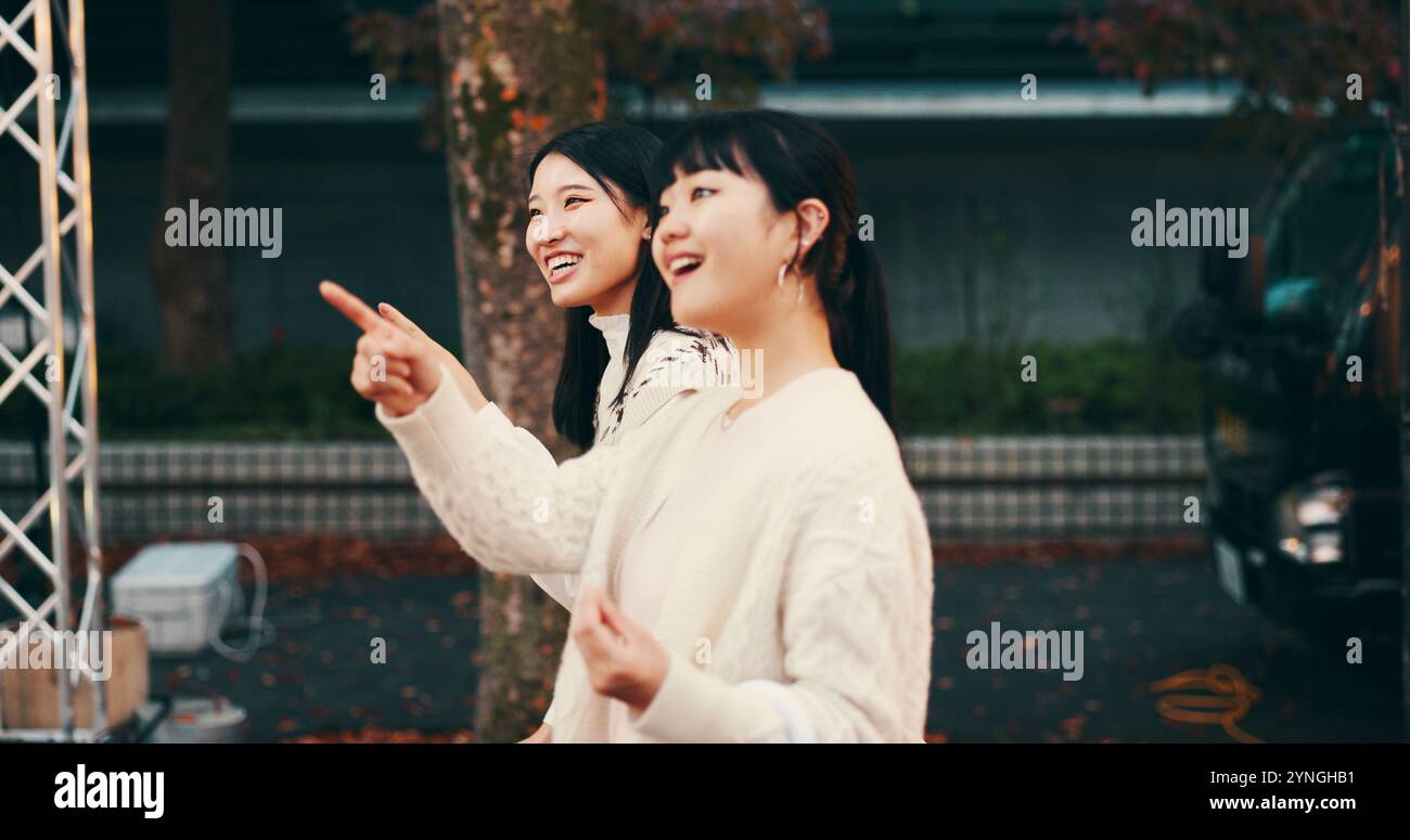 Travel, pointing and Asian women in city, tourism and bonding with ...