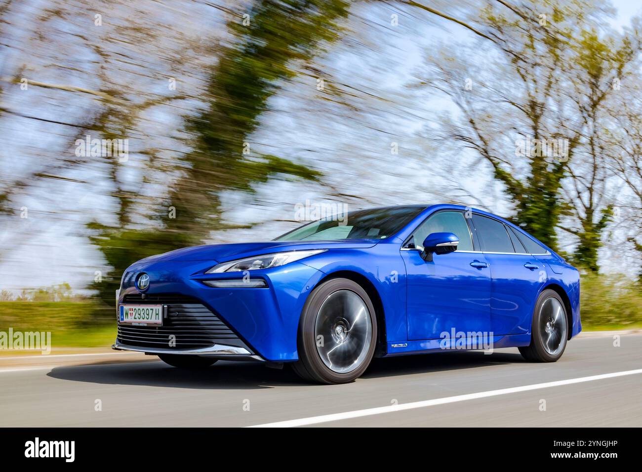 Toyota Mirai hydrogen fuel cell car on the road. Mirai combines hydrogen with oxygen from the ...