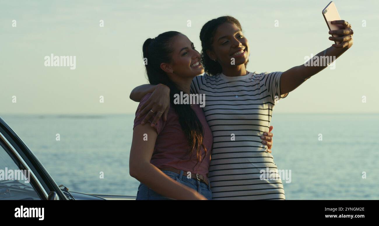 Women, hug and outdoor selfie on holiday, friends and photography to capture memory on road trip ...