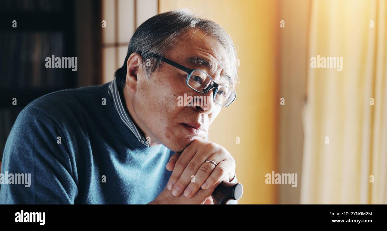 Thinking, senior and japanese man with walking stick and sad memory with struggle to remember ...