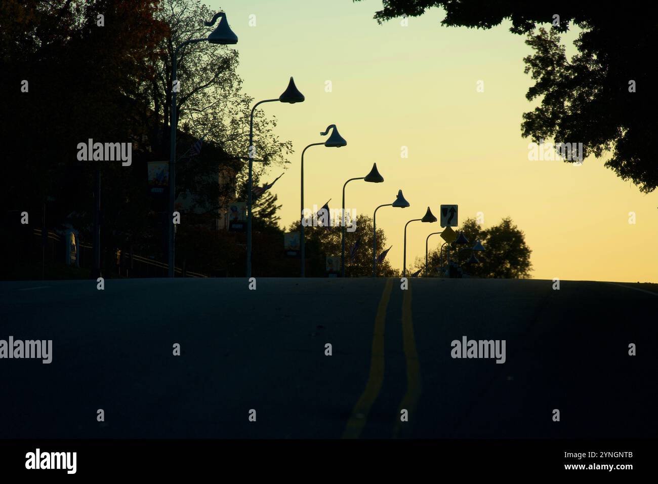 Hershey Kiss-shaped streetlights are silhouetted by the setting sun in ...