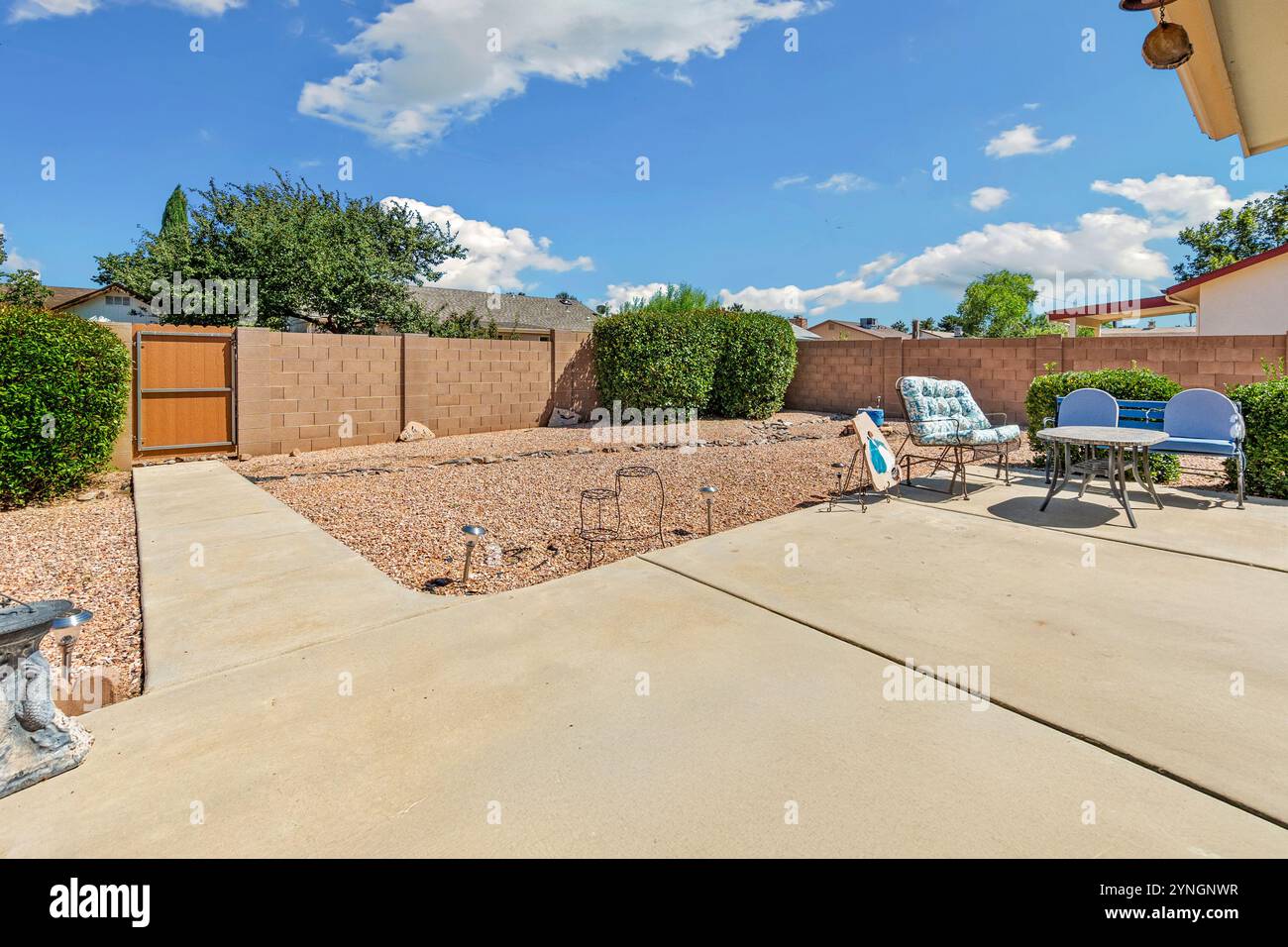 Relaxing outdoor patio space with desert landscaping and blue skies ...