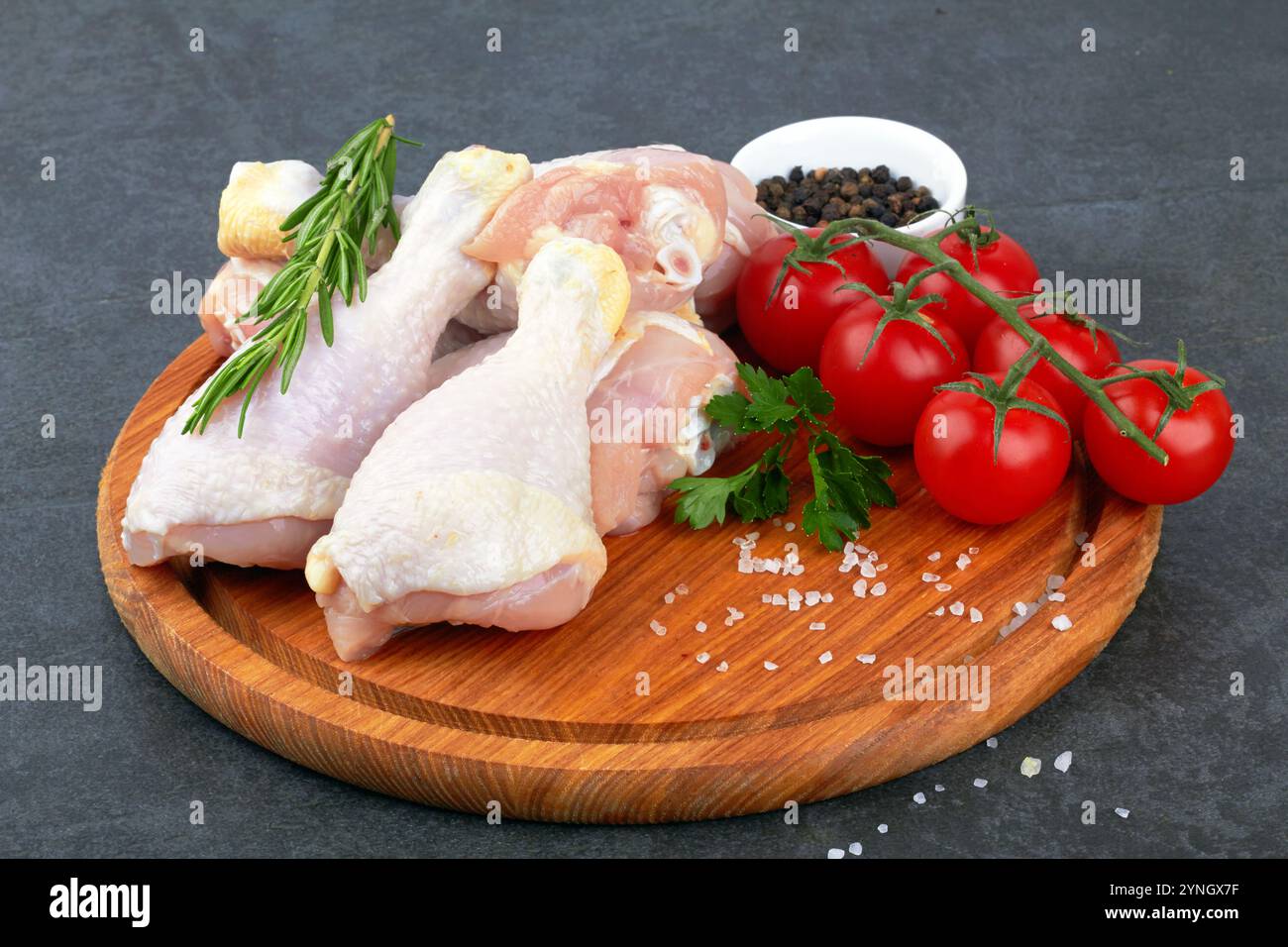 Chicken legs on stone black background Stock Photo - Alamy
