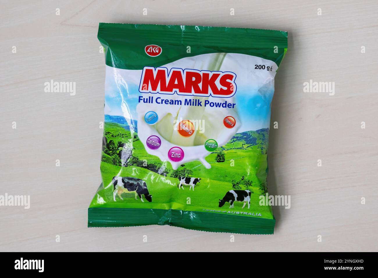 A packet of MARKS Full Cream Milk Powder on a wooden surface. It's ...