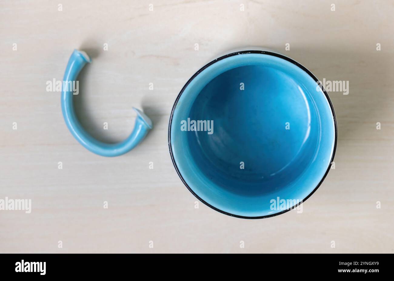 Top view of a broken mug and its broken handle lying on the floor Stock ...